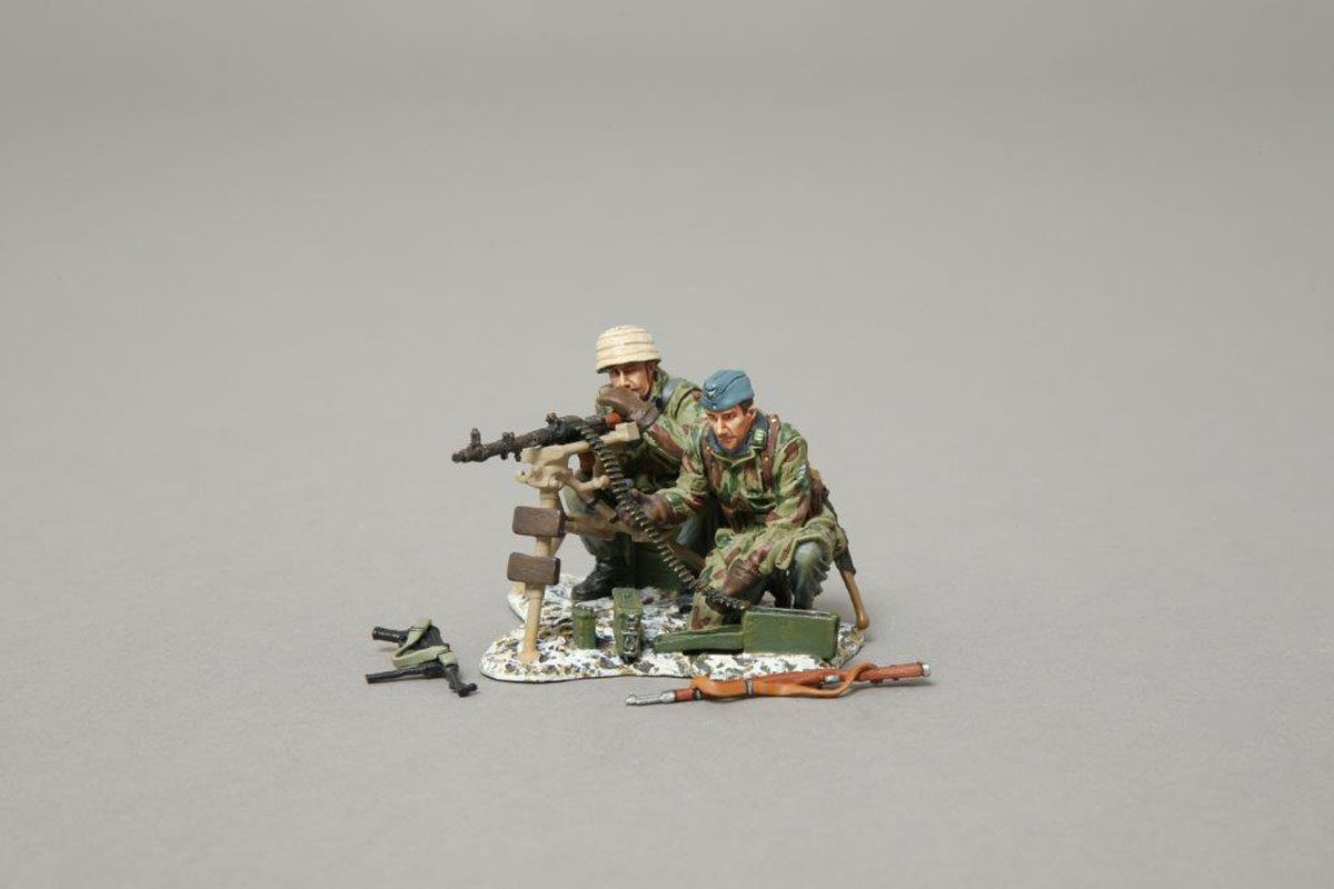 A Fallschirmjager Heavy Machine Gun crew take aim of their MG34 whilst ...